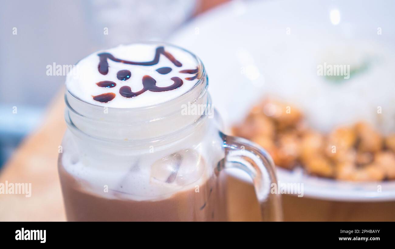 cute cat on top milk foam latte art coffee cup Stock Photo - Alamy