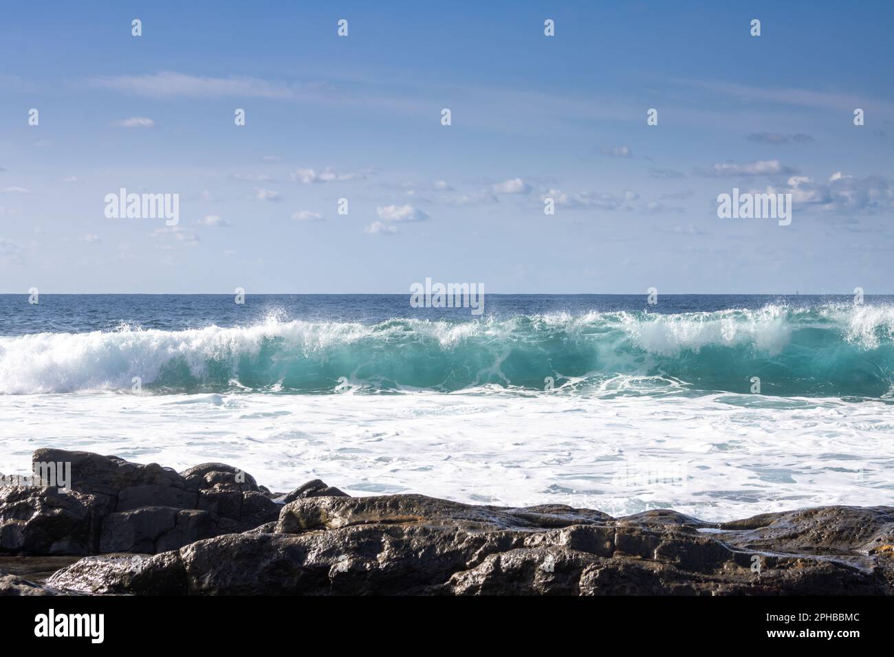 Beach of the Atlantic ocean with a rocky coast. Calm water in the ...