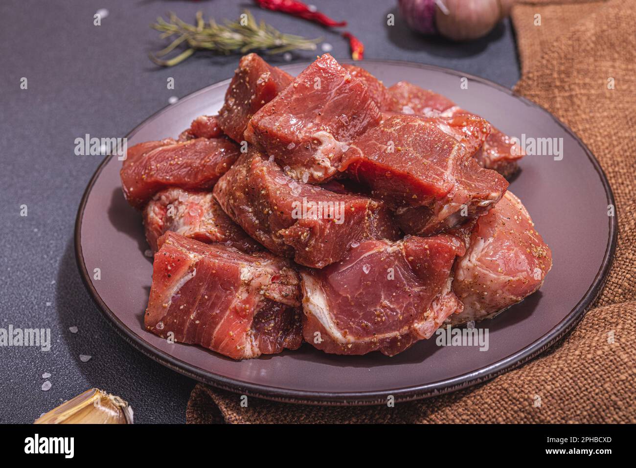 Raw pork loin pieces with ground spices. Marinated meat cuts ...