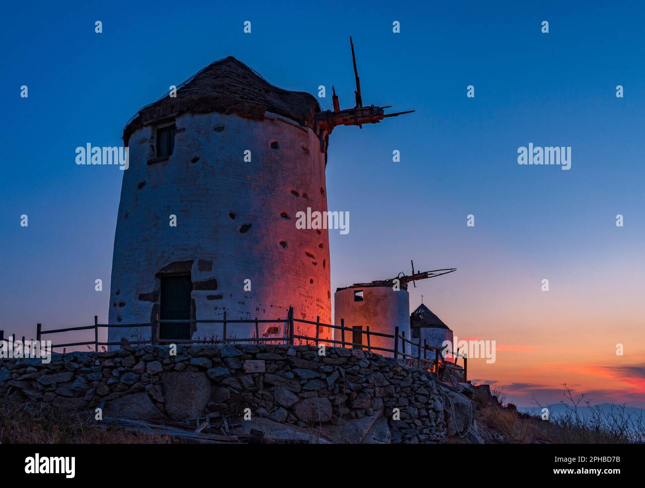 Traditional Cycladic windmills in Vivlos village at dusk, Naxos Stock Photo - Alamy
