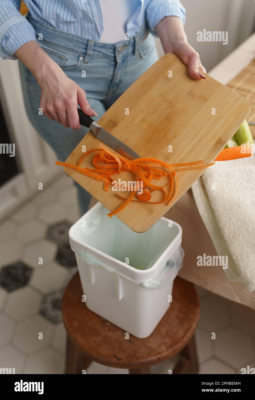 Person composting organic food waste. Female recycling leftovers in a ...