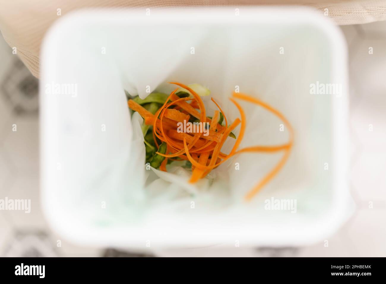 Organic food waste in a bokashi container. Kitchen composter bin with ...