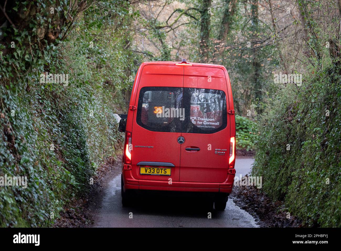 A local number 35 bus service makes its way through a narrow lane in ...