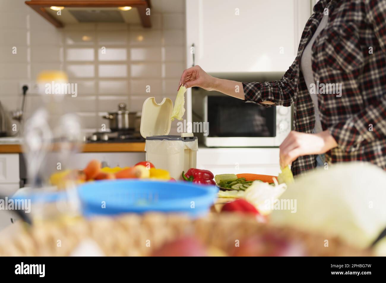 Person recycling organic food leftovers in bokashi container. Female ...