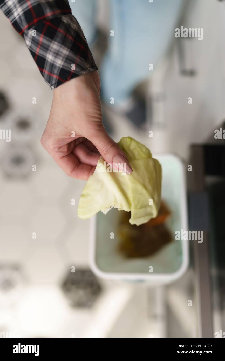 Female putting organic food waste in a bokashi container. Woman ...