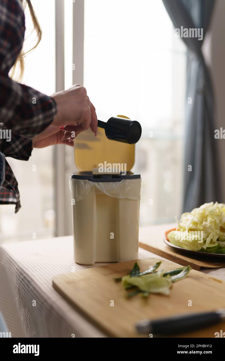 Woman put bokashi ferment into composter bin. Female person recycling ...