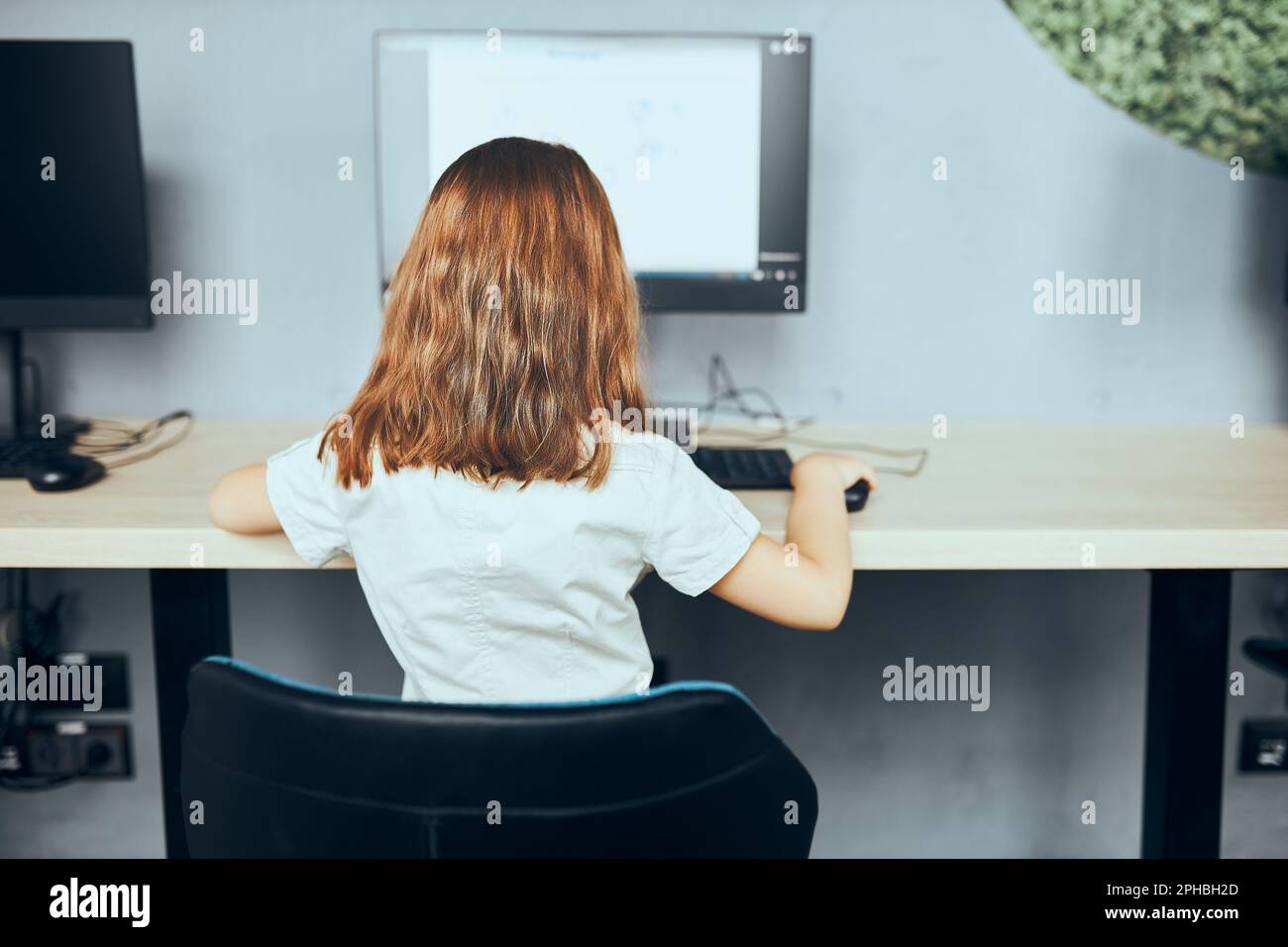 Child learning to use technology in classroom at primary school ...