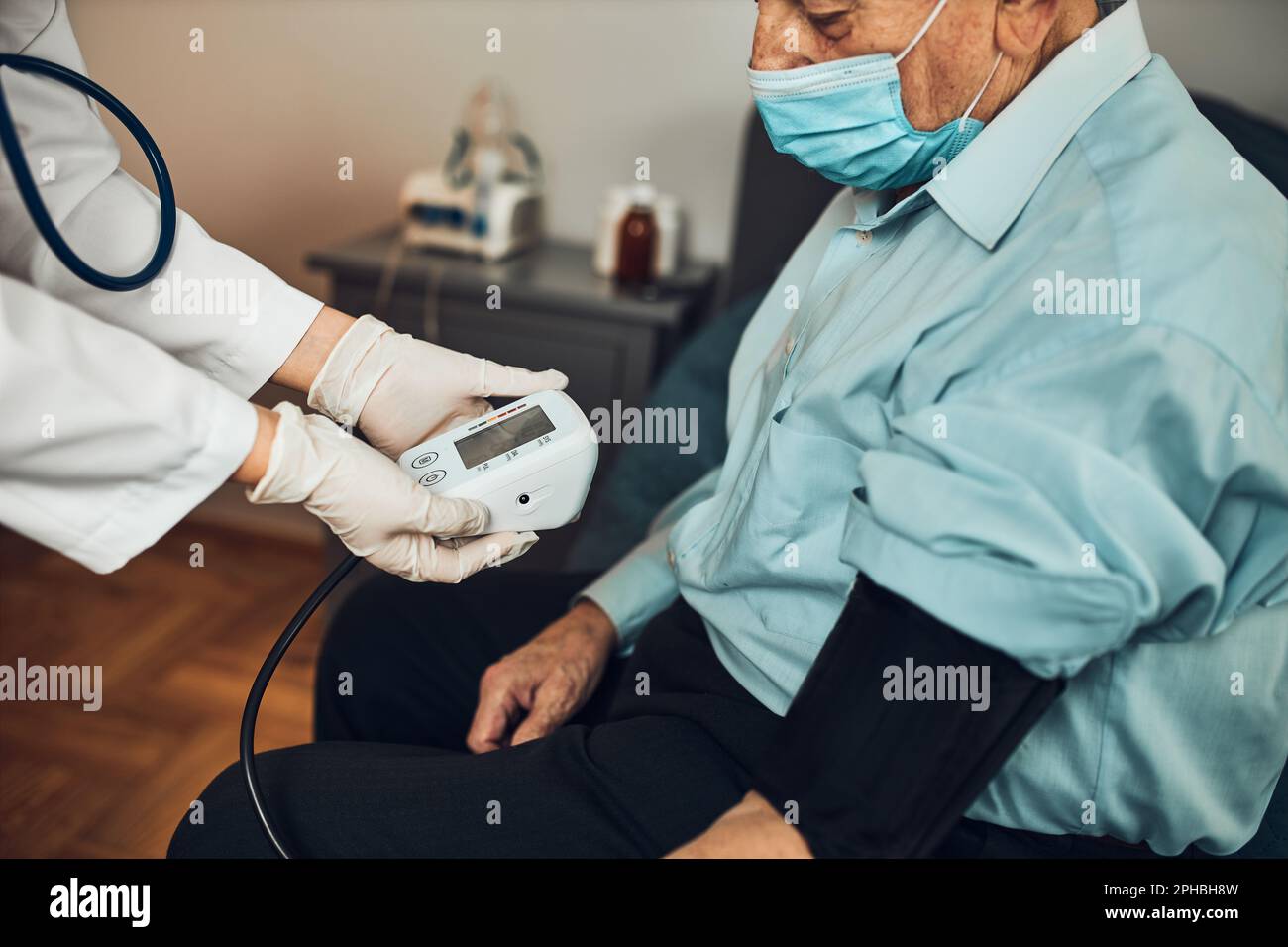 Doctor carying out blood pressure test and heart rate of senior man ...