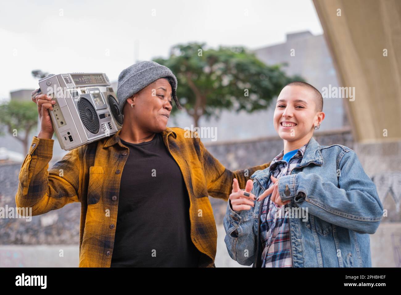 Hip hop group singing and dancing to music playing on vintage radio ...