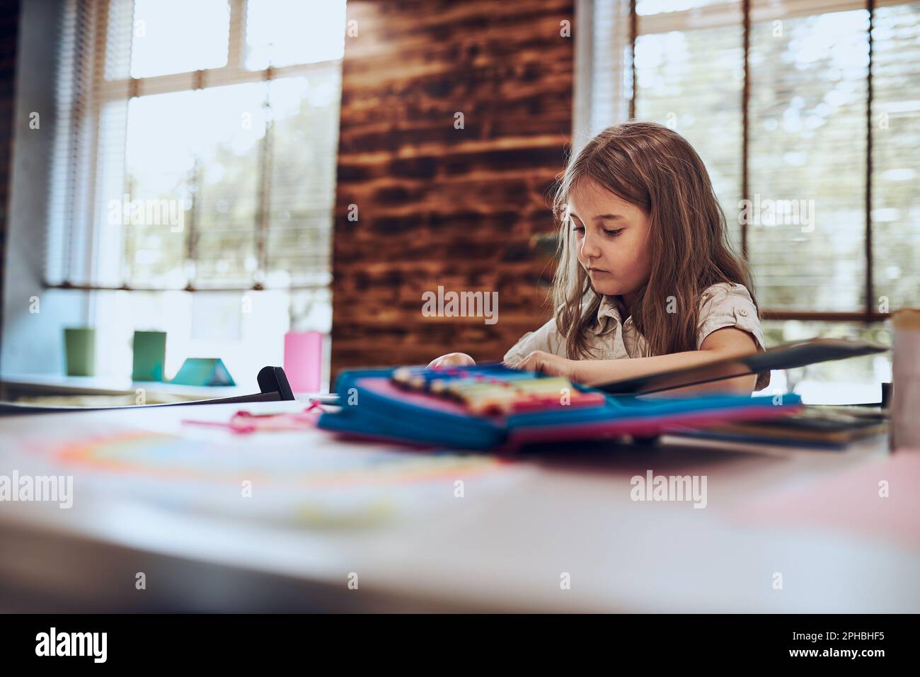 Girl doing homework, learning, drawing pictures, doing puzzles in ...