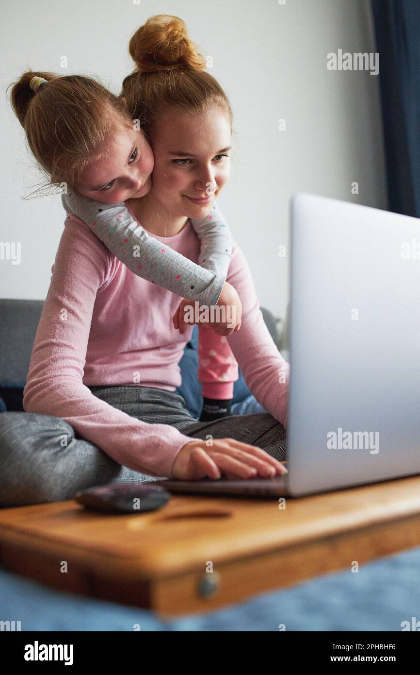 Grandchildren teenage girl and her younger sister talking on video call ...