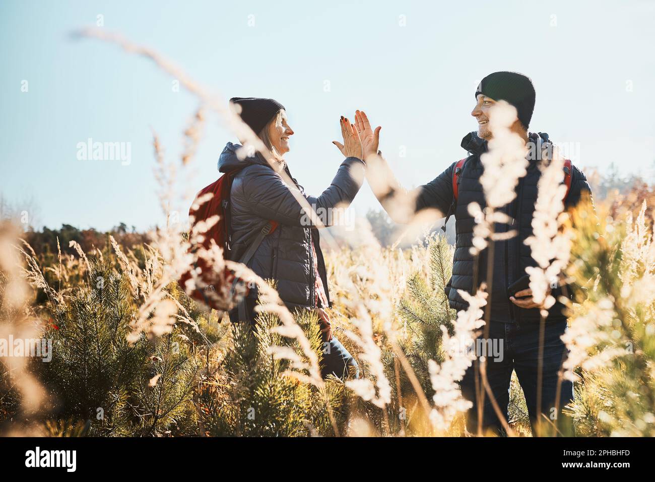 Friends enjoying trip in nature, giving high five while vacation day ...