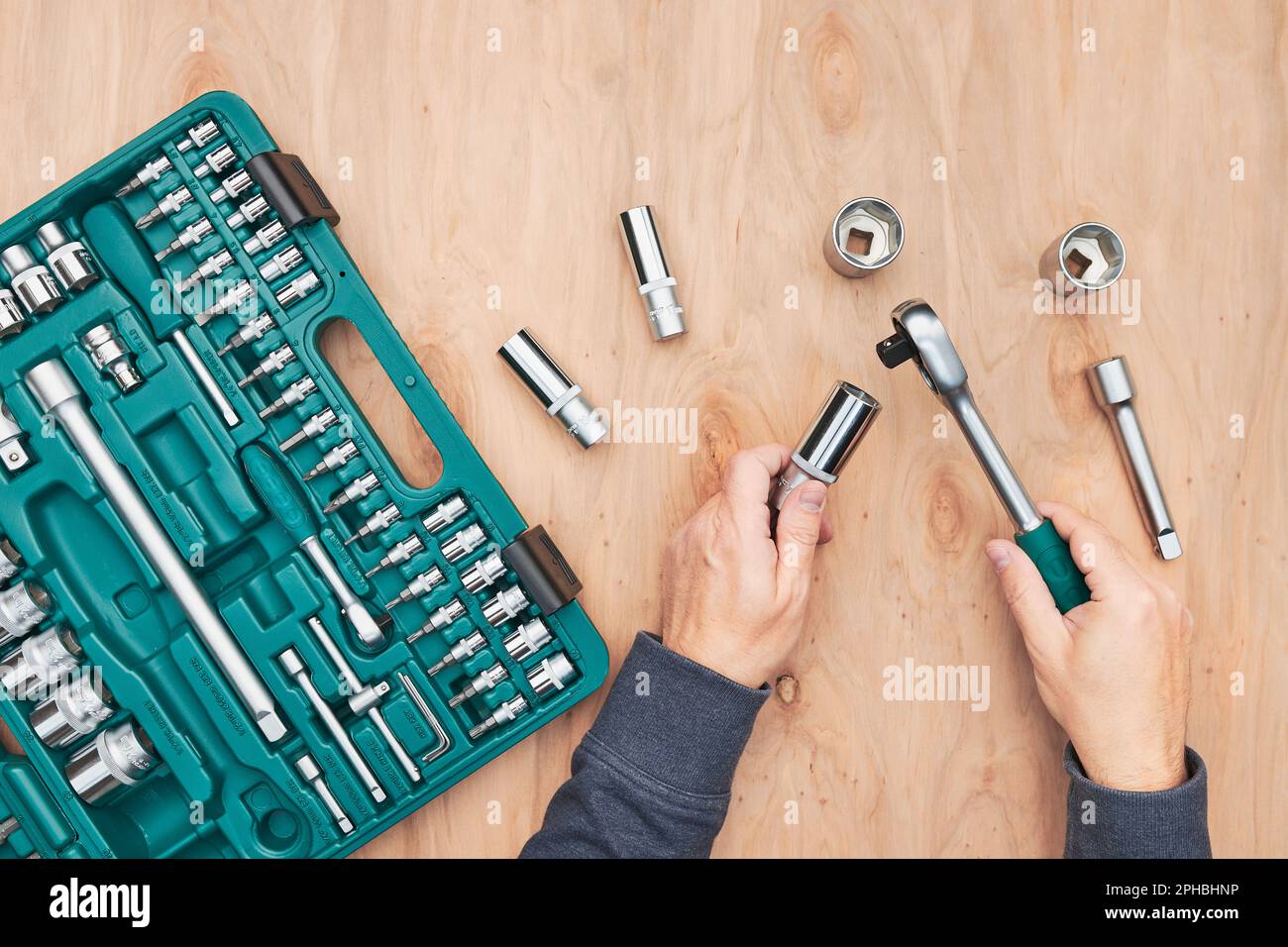 Man working in workshop using many tools. Wrench, spanner, calliper and ...