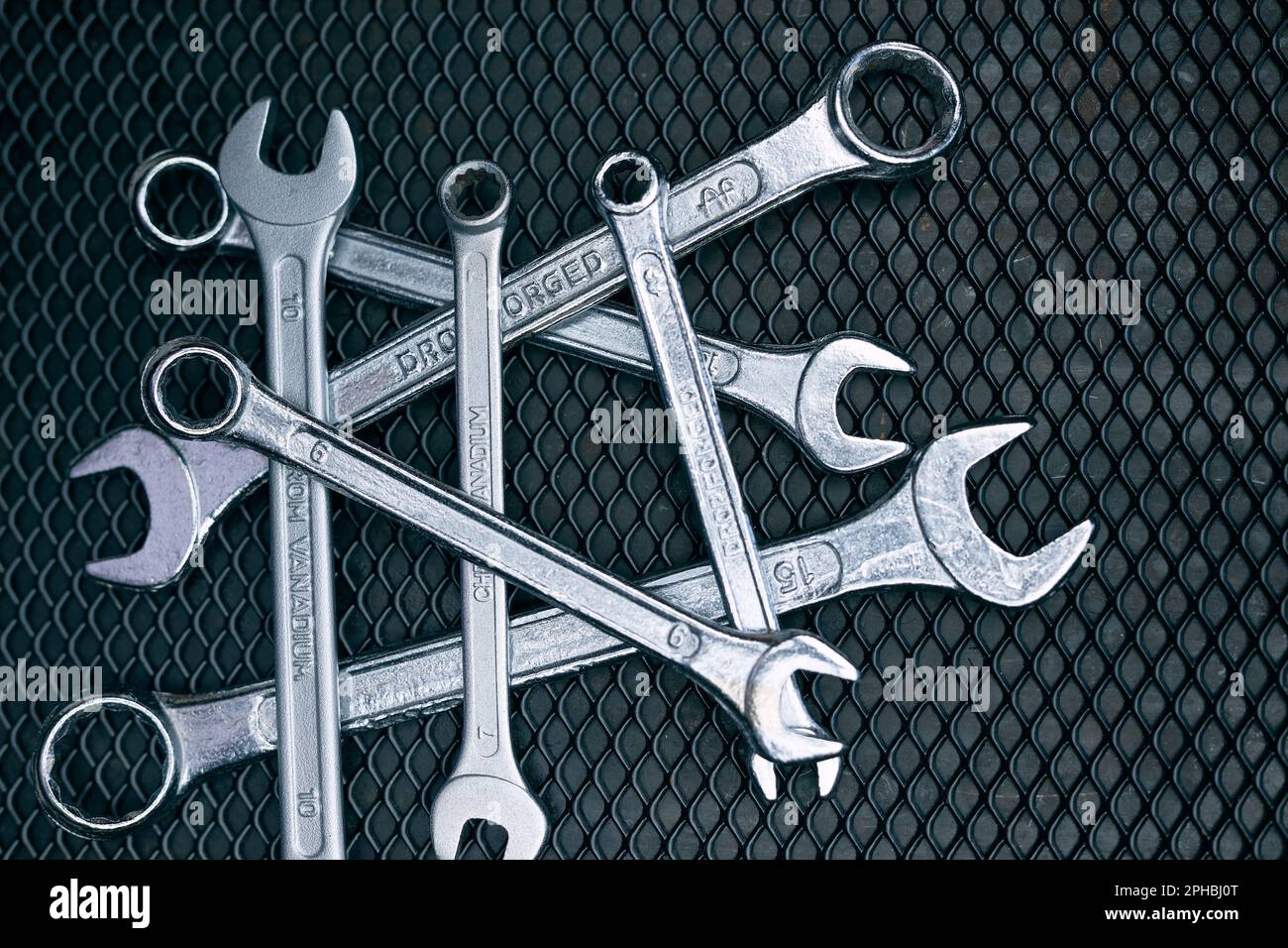 Set of chrome wrenches on steel surface. Mechanic tools for maintenance ...