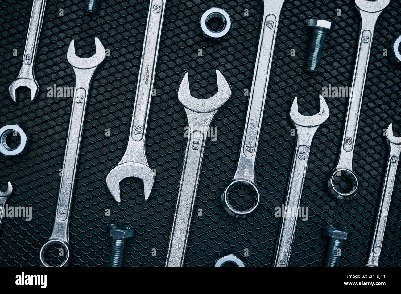 Set of chrome wrenches on steel surface. Mechanic tools for maintenance ...