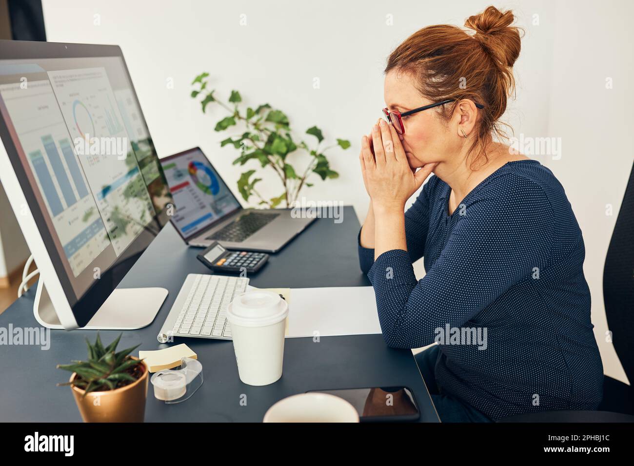 Stressed woman entrepreneur focused on solving difficult work. Confused ...