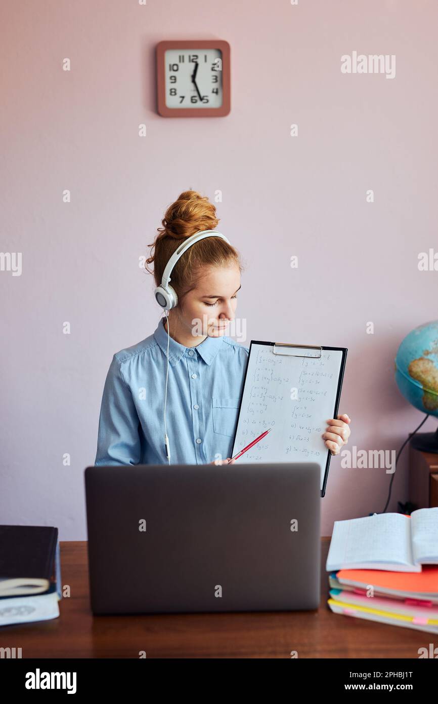 Young woman student showing homework, having classes, learning online ...