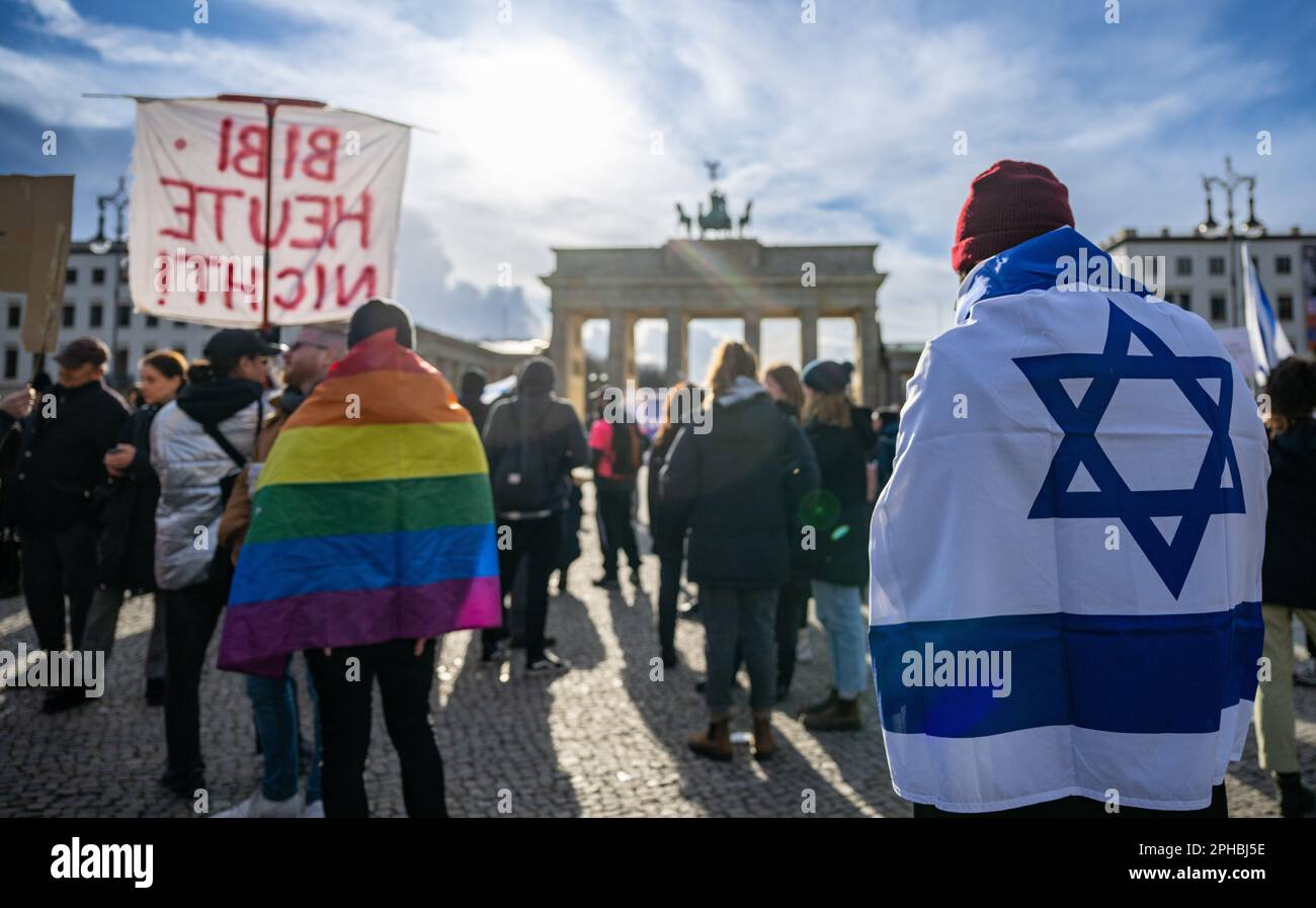 Berlin, Germany. 27th Mar, 2023. Demonstrators stand with signs, flags ...