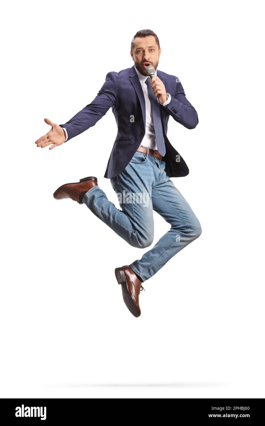 Excited man with a microphone jumping and singing isolated on white ...