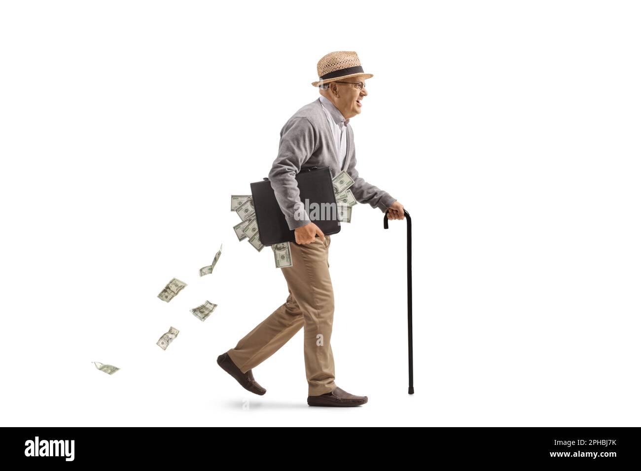 Full length profile shot of an edlery man walking with a cane and ...