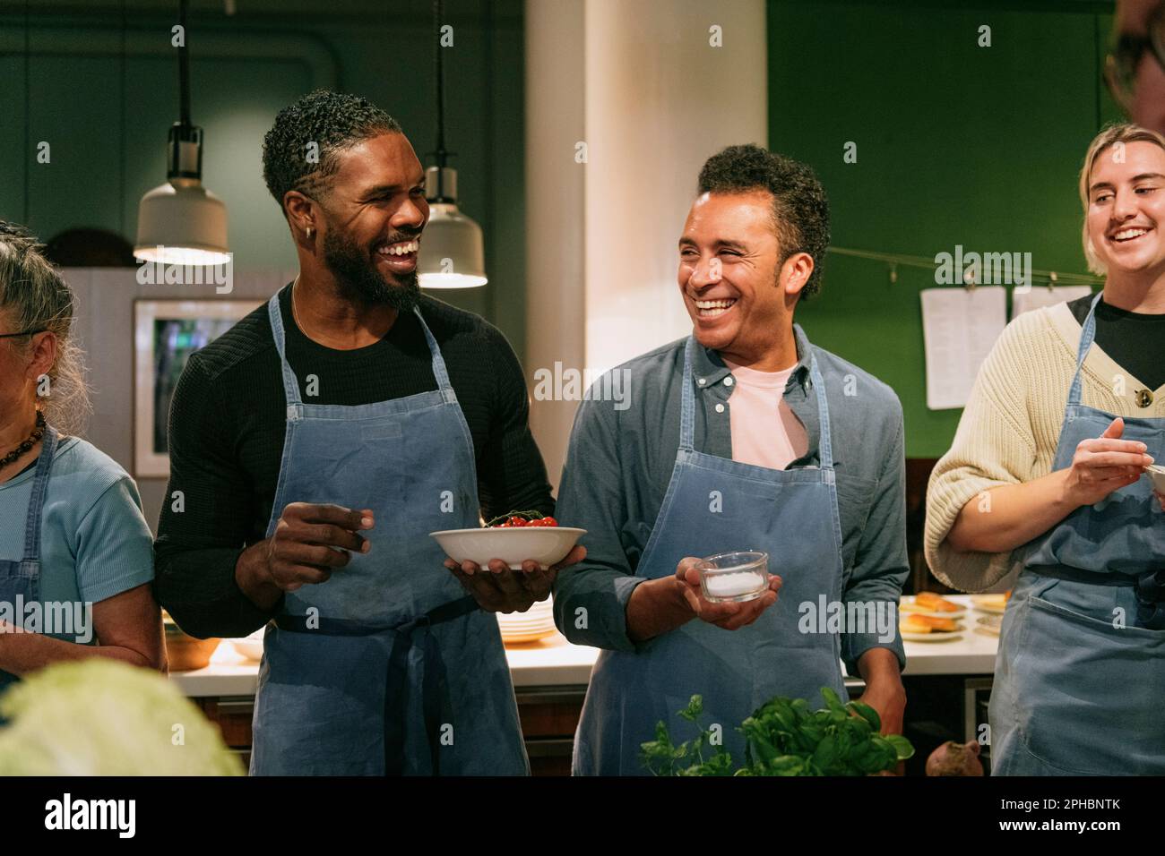 Multiracial students laughing during cooking class in kitchen Stock ...