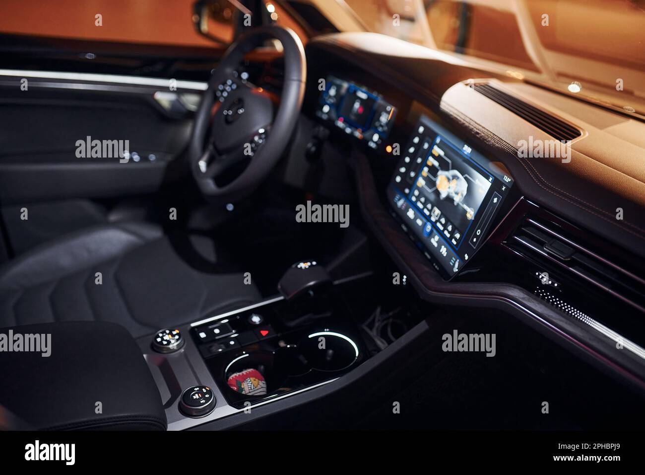 Steering wheel and navigation display. Close up view of front park of ...