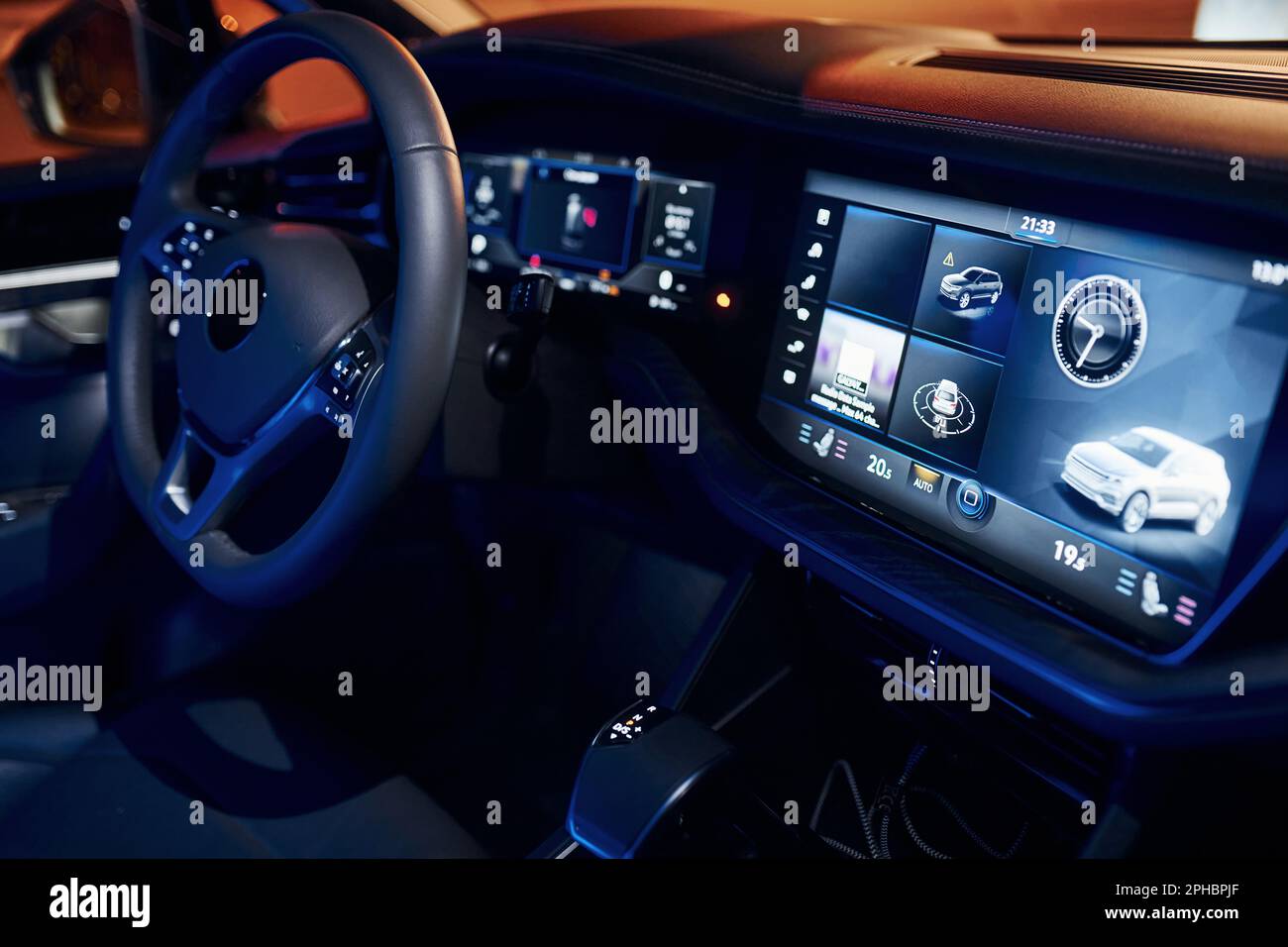 Steering wheel and navigation display. Close up view of front park of ...