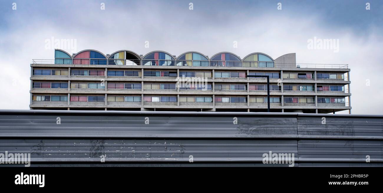 Apartment building with coloured curtains Stock Photo - Alamy