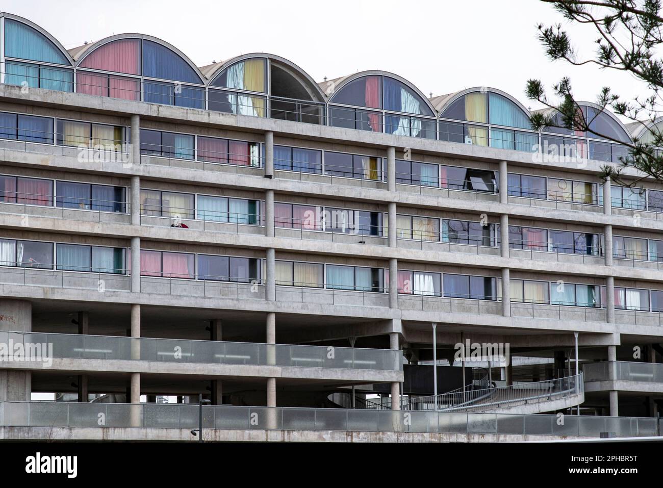 Apartment building with coloured curtains Stock Photo - Alamy