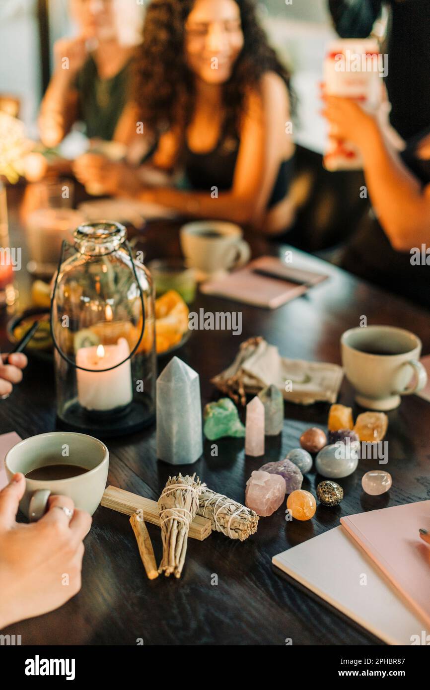 Sage and variety of crystals arranged on dining table at retreat center ...