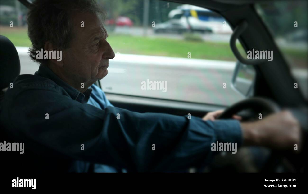 One senior man driving car on road. Profile face of older male ...