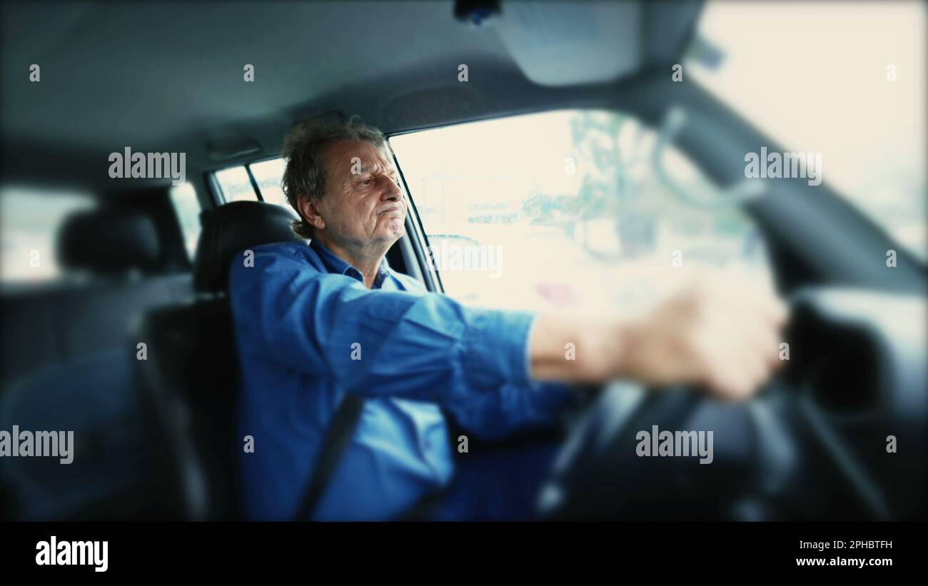 Older man driving moving car sitting inside vehicle Stock Photo - Alamy