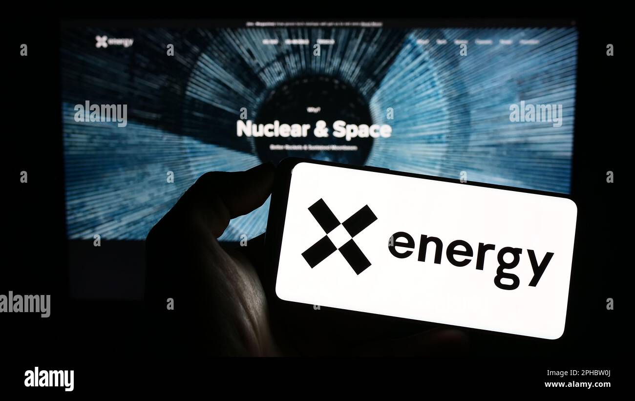Person holding cellphone with logo of US nuclear energy company X ...