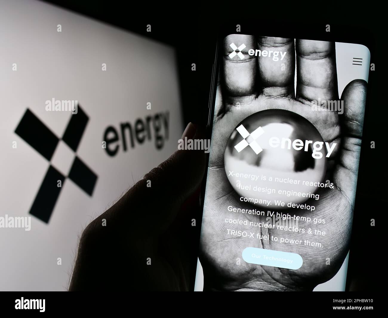 Person holding smartphone with website of US nuclear energy company X ...