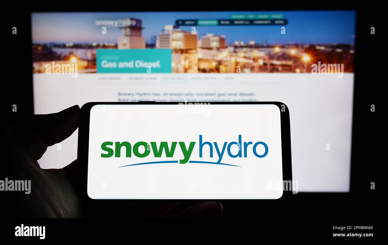 Person holding mobile phone with logo of Australian energy company ...