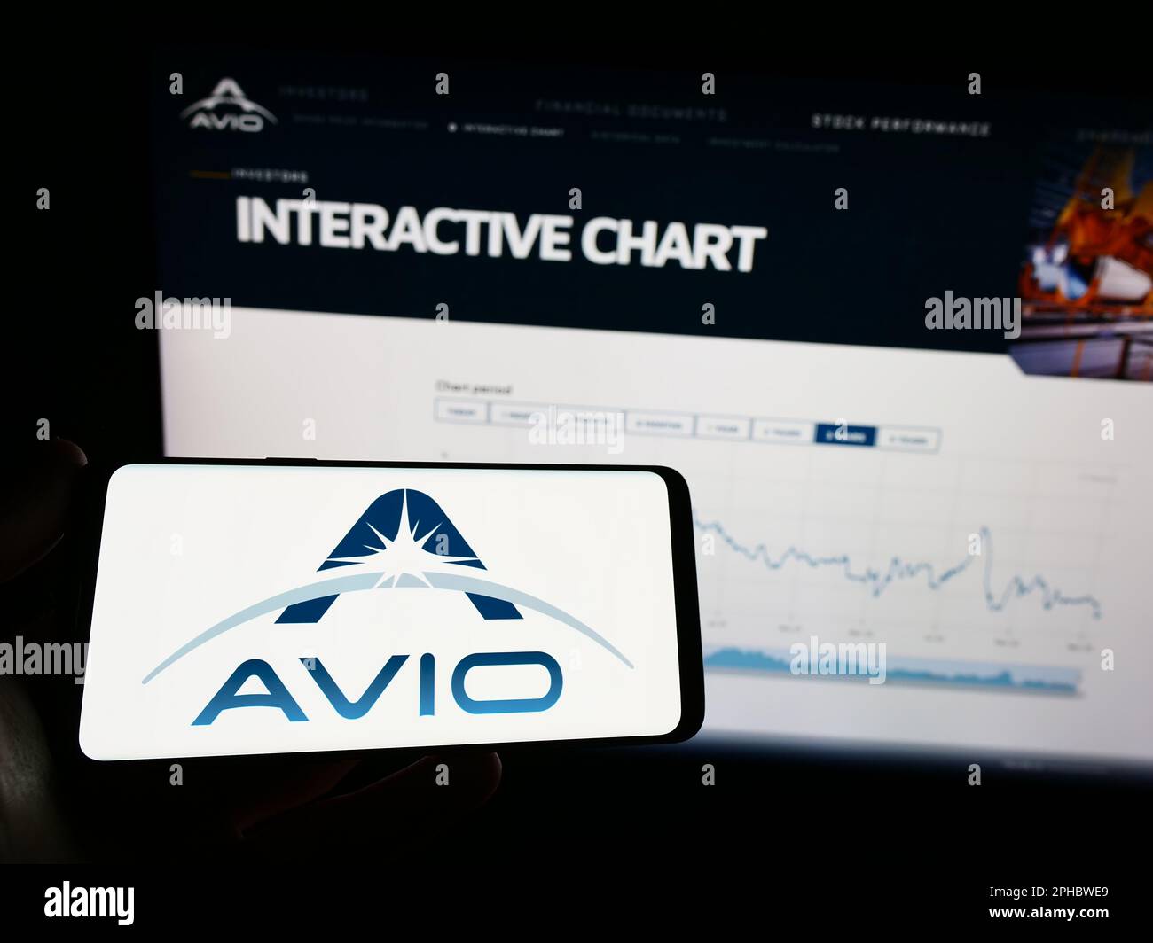 Person holding mobile phone with logo of Italian aerospace company Avio ...