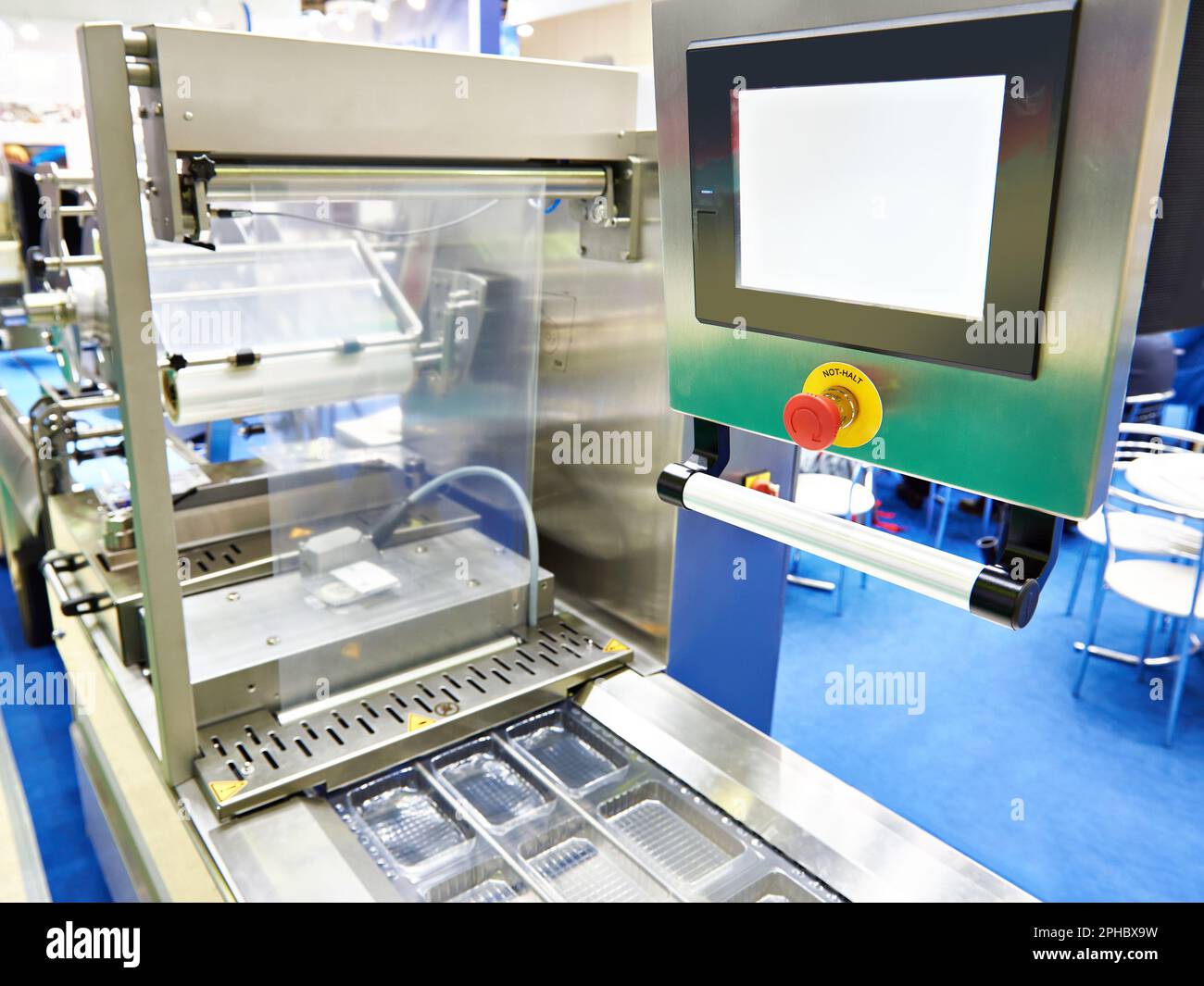 Conveyor at food factory for packing plastic containers Stock Photo - Alamy