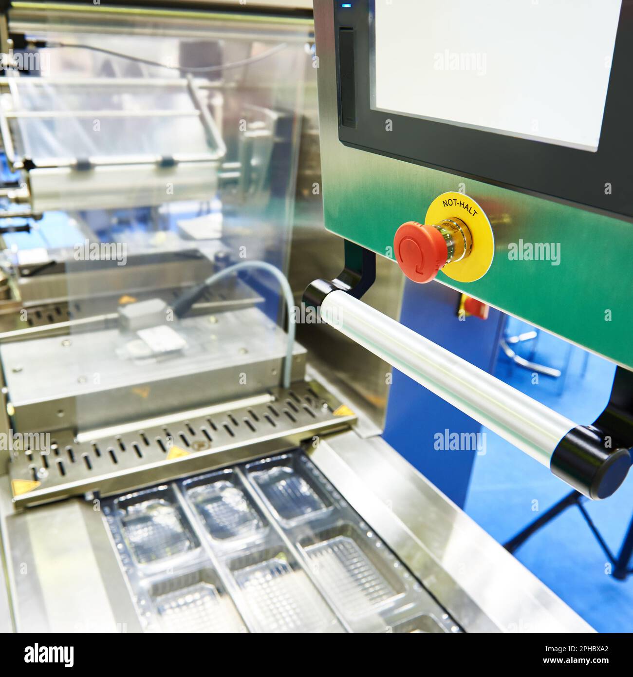 Conveyor at food factory for packing plastic containers Stock Photo - Alamy