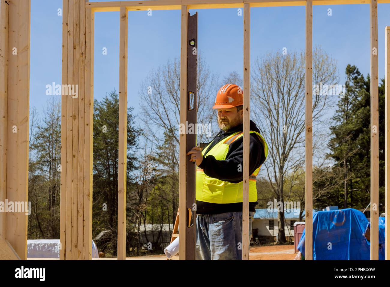 Using level an construction engineer checks leveling quality of wooden ...