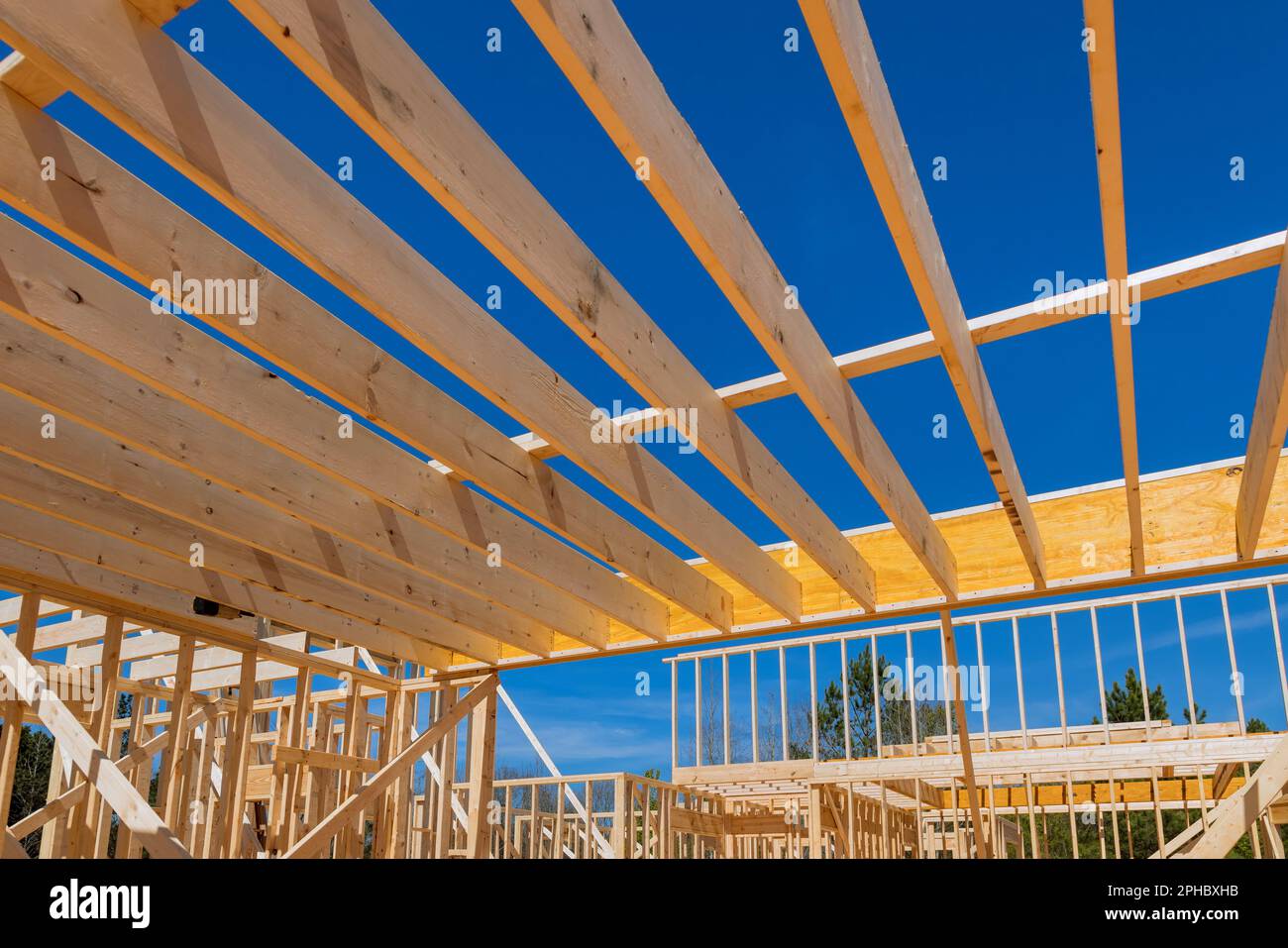 Building wooden house begins with framing beams which support layout of ...