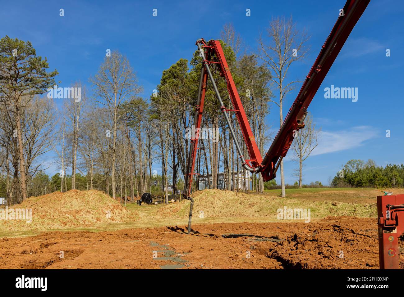Pouring cement concrete for foundation of house using an automatic pump ...