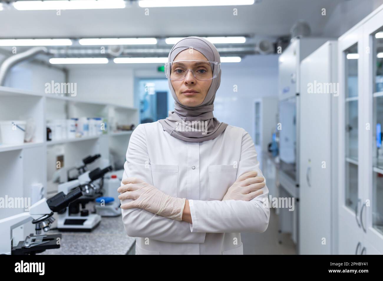 Portrait of a young Muslim female lab technician, pharmacist in hijab ...