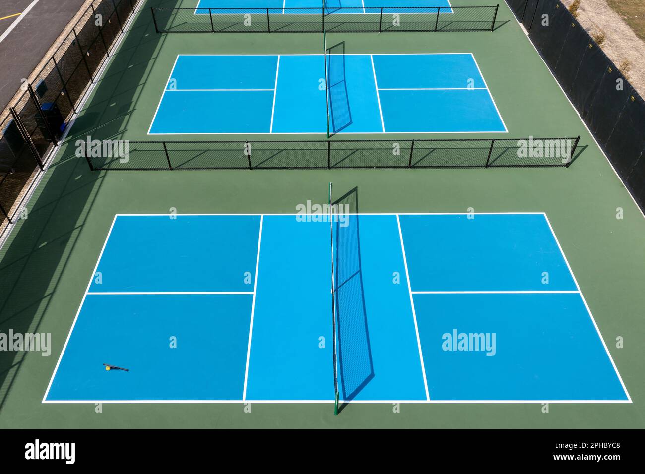 Aerial view of a new pickleball facility with blue and green courts in ...