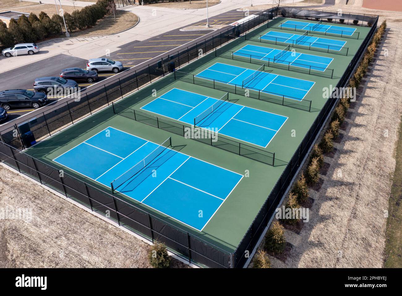 Aerial view of a new pickleball facility with blue and green courts in ...