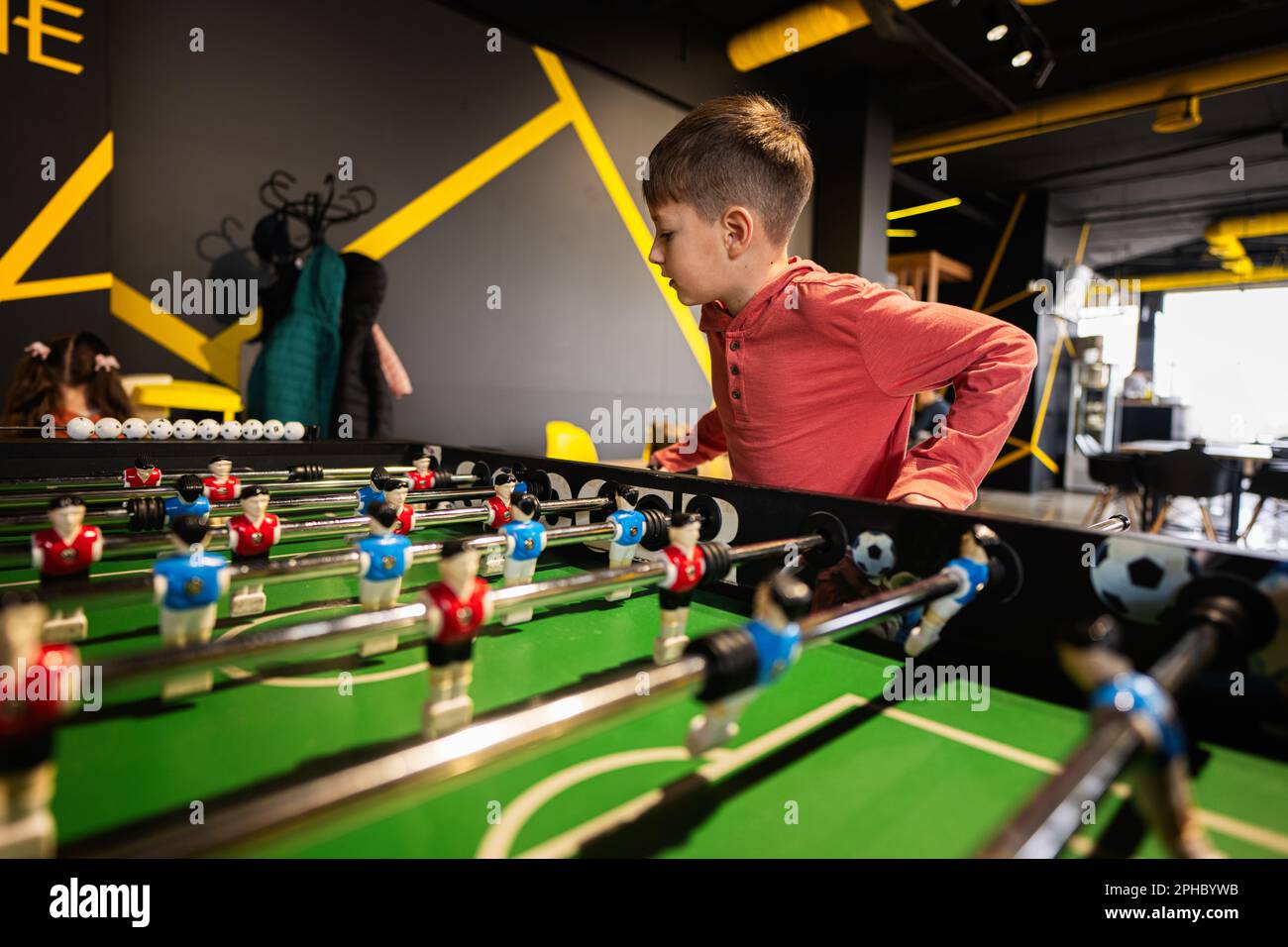 Boy playing table football in kids play center Stock Photo - Alamy