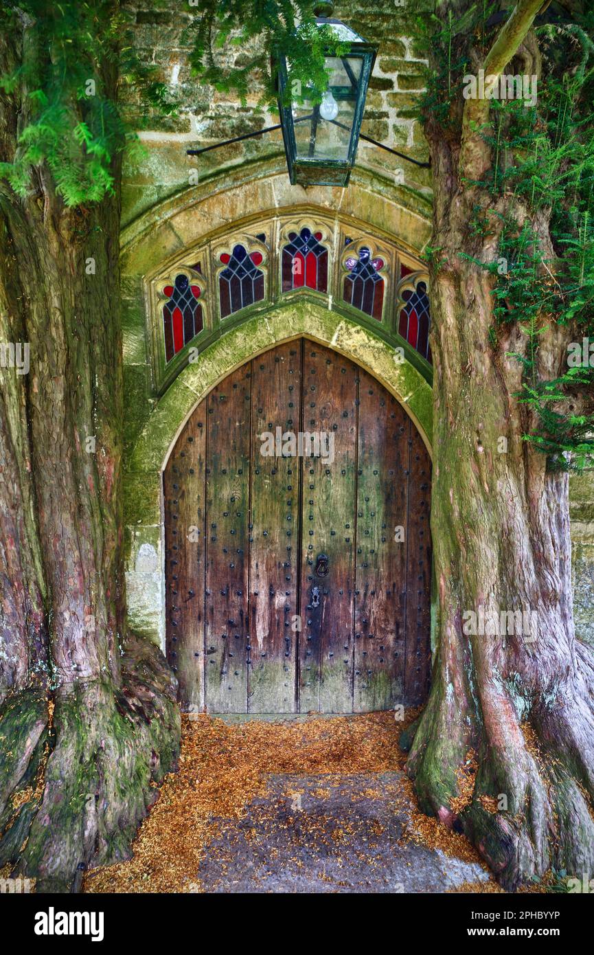 Wooden Door of St Edwards church with two ancient yew trees, Stow-on ...