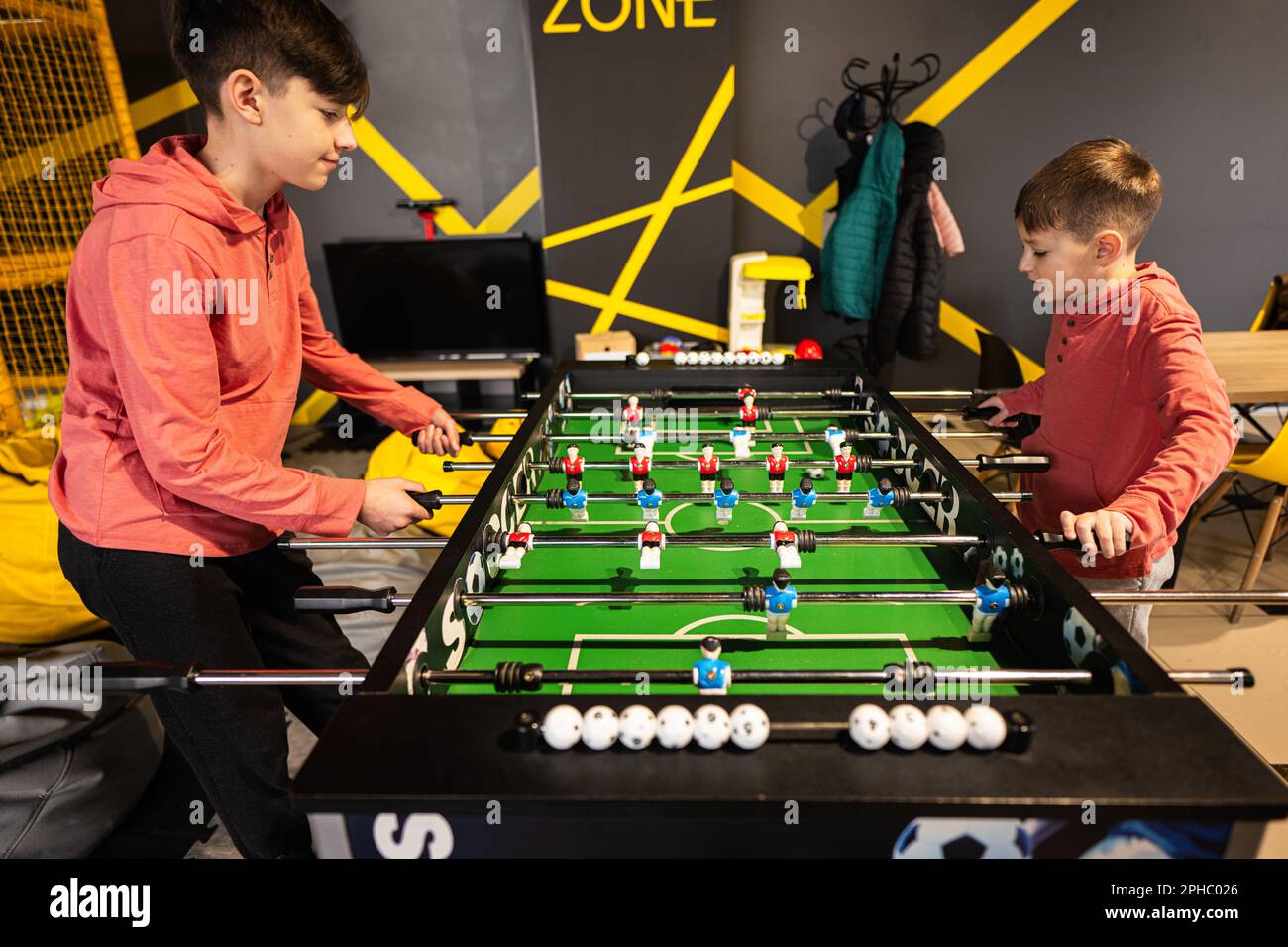 Kids playing soccer in room hi-res stock photography and images - Alamy