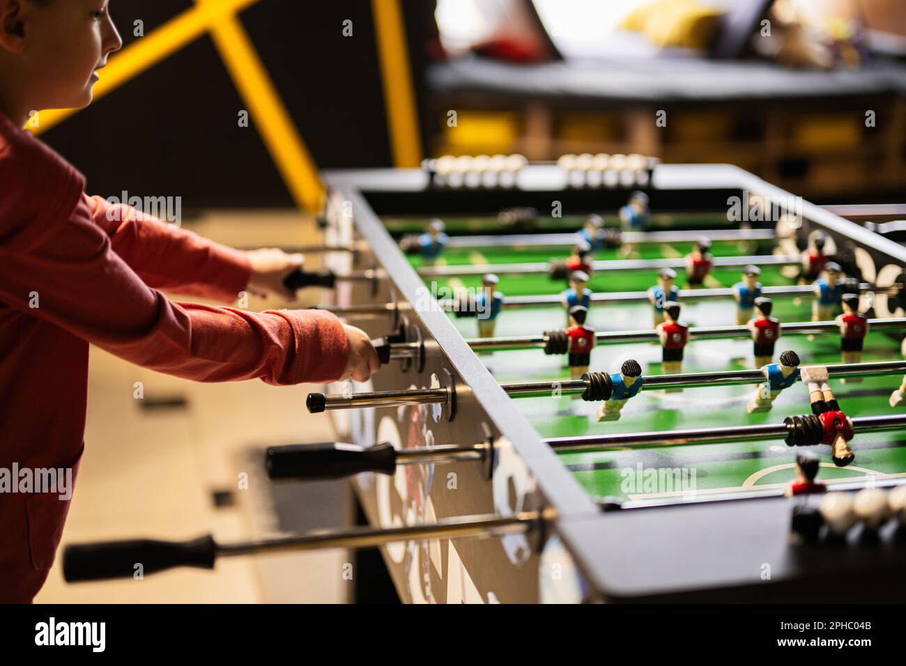 Boy playing table football in kids play center Stock Photo - Alamy
