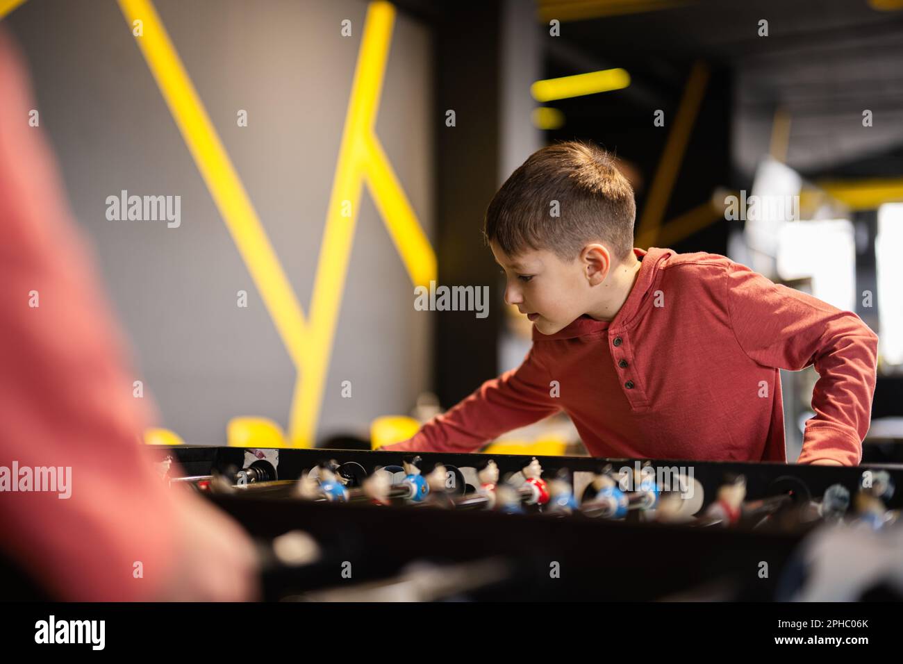 Boy playing table football in kids play center Stock Photo - Alamy