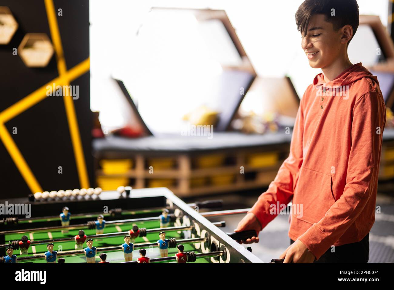 Boy playing table football in kids play center Stock Photo - Alamy